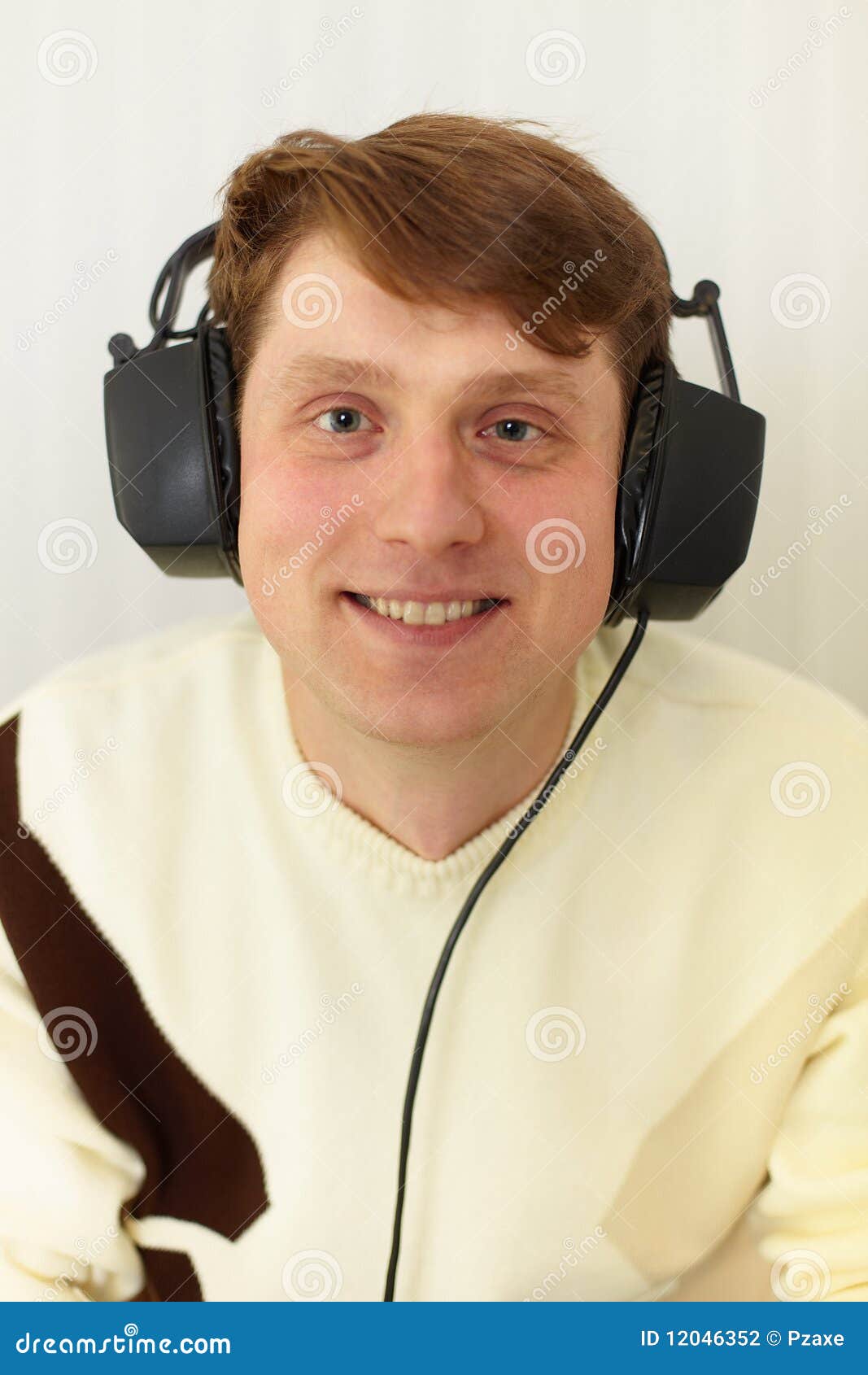 Cheerful Guy with Big Ear-phones on a Head Stock Photo - Image of young ...