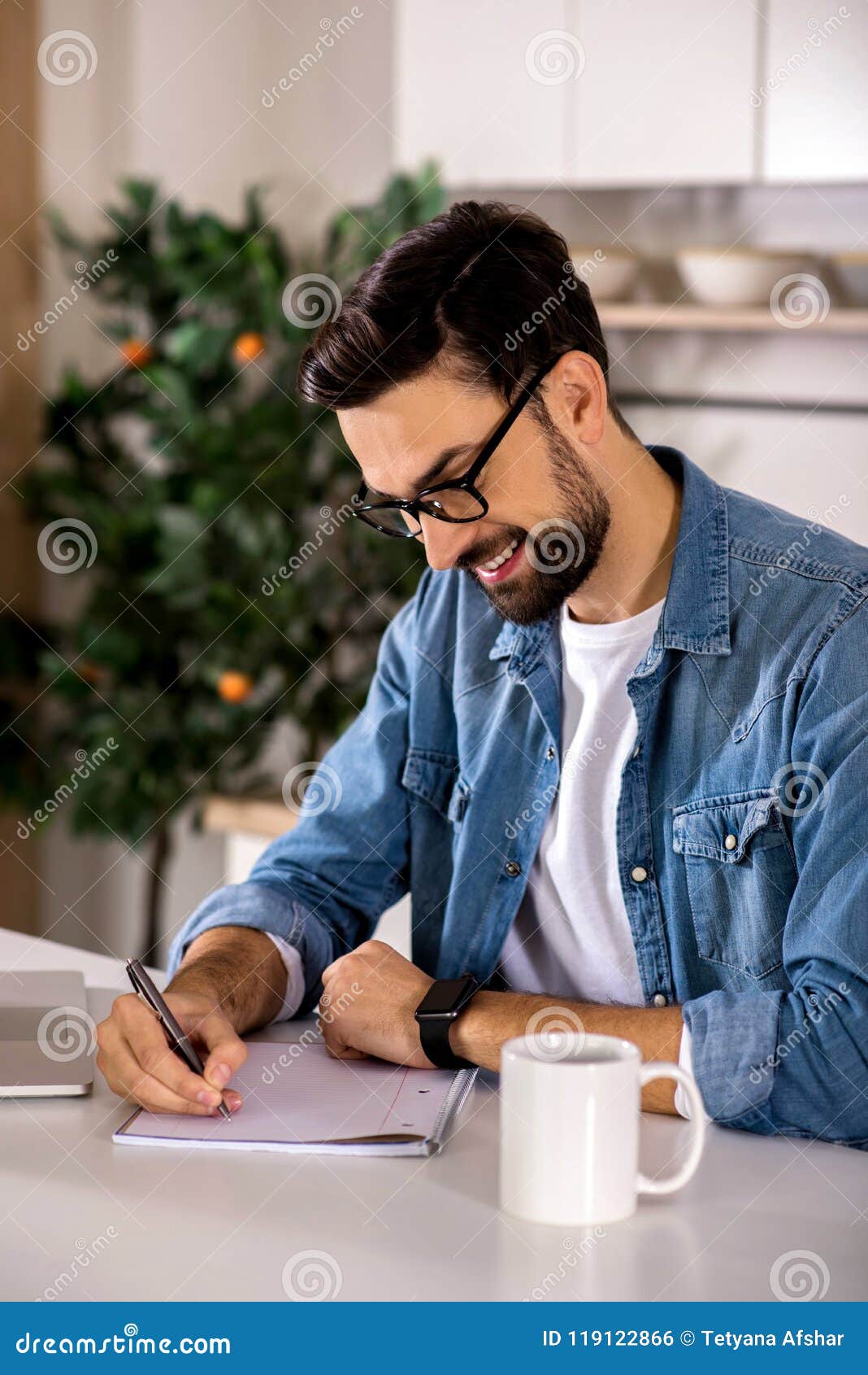 Cheerful Handsome Man Making Notes Stock Photo - Image of news ...