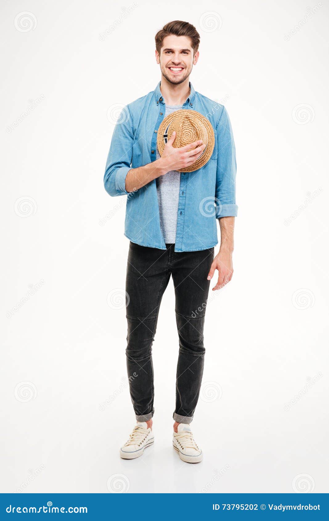 Cheerful Handsome Young Man Standing and Holding Hat Stock Photo ...