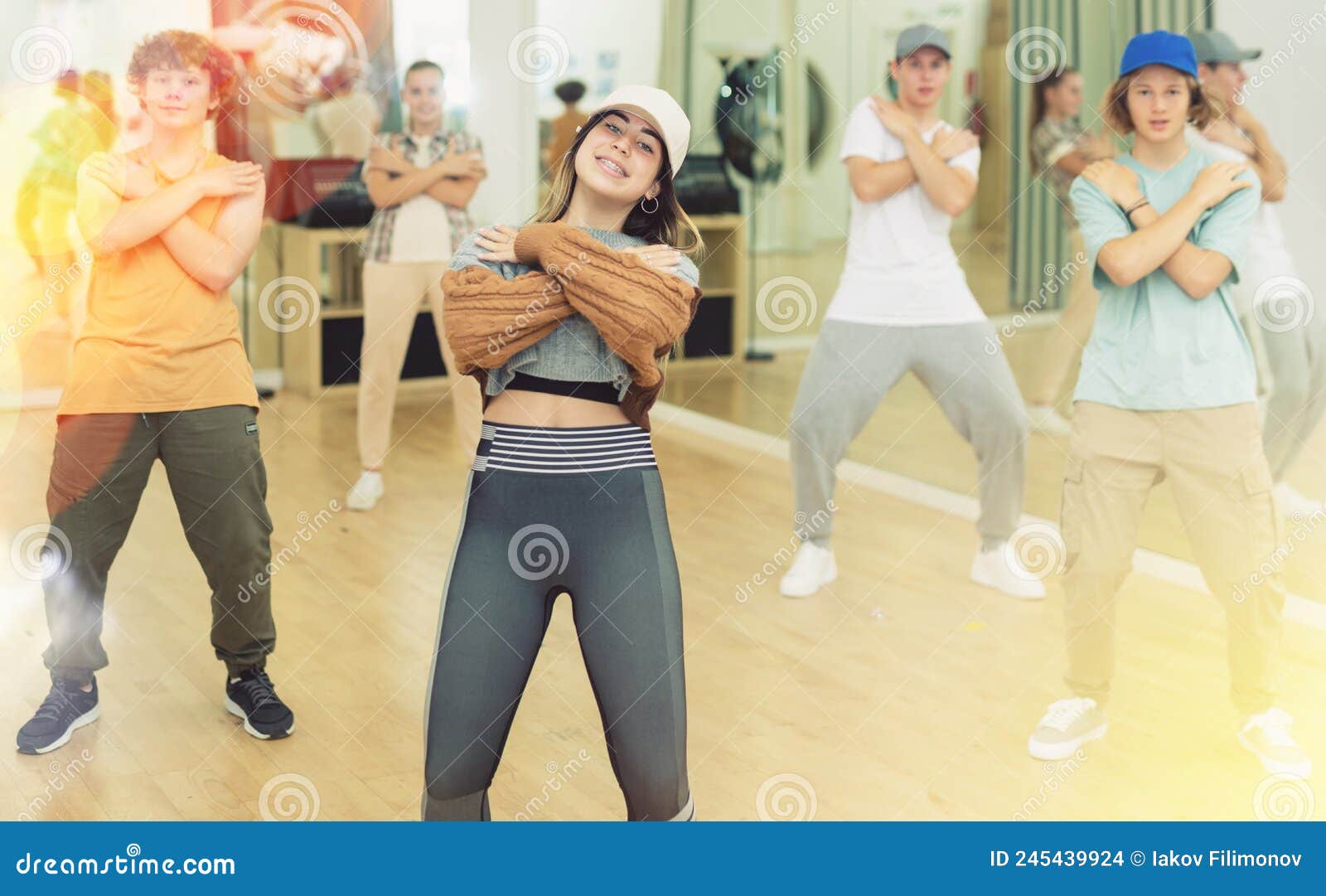 Cheerful Hispanic Teenage Girl Practicing Hip-hop Movements in Studio ... Cheerful Hispanic Teenage Girl Practicing Hip-hop Movements in Studio ...