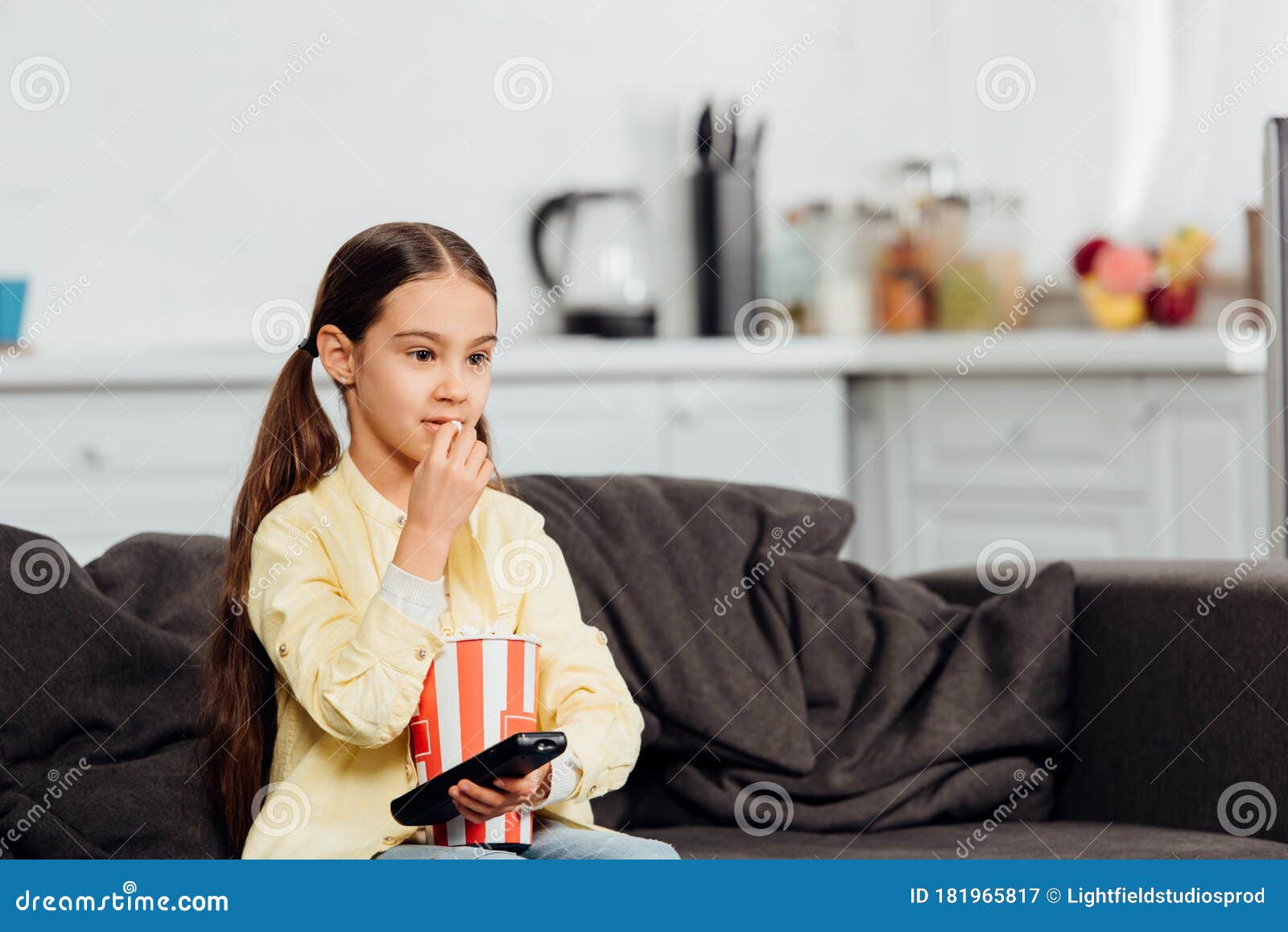 Cheerful Kid Holding Remote Controller while Eating Tasty Popcorn ...