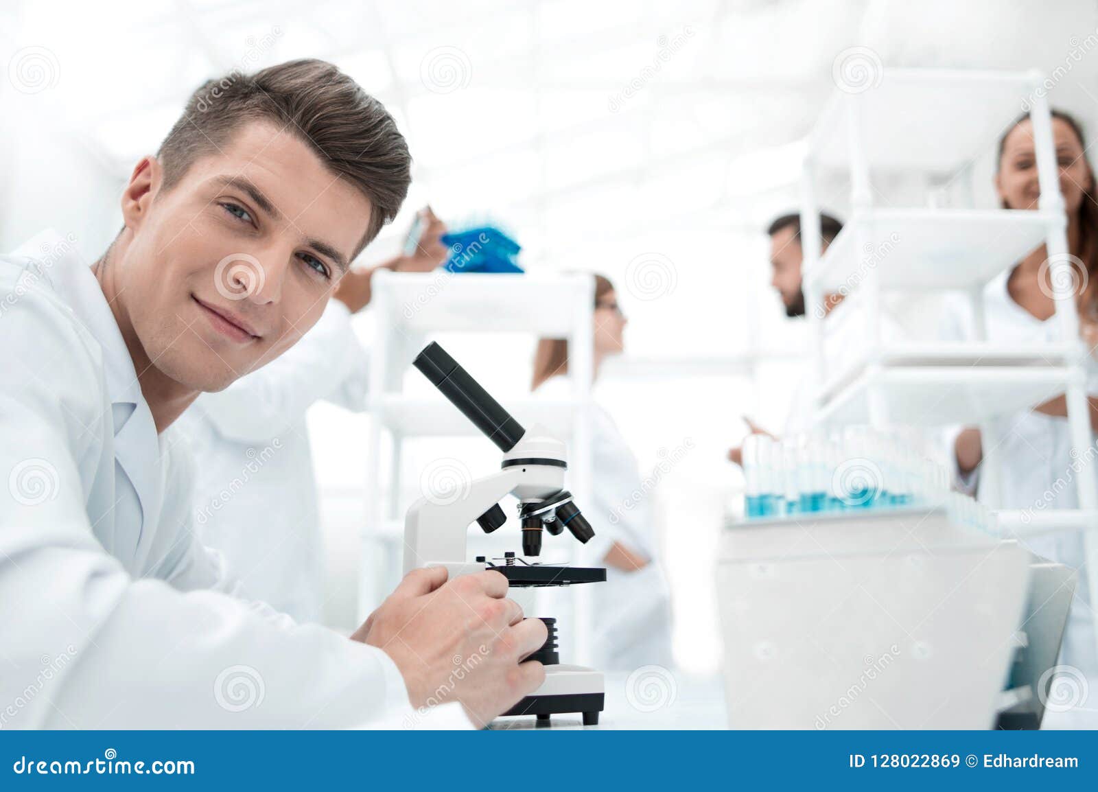 Cheerful Laboratory Worker Using Microscope in Lab Stock Image - Image ...