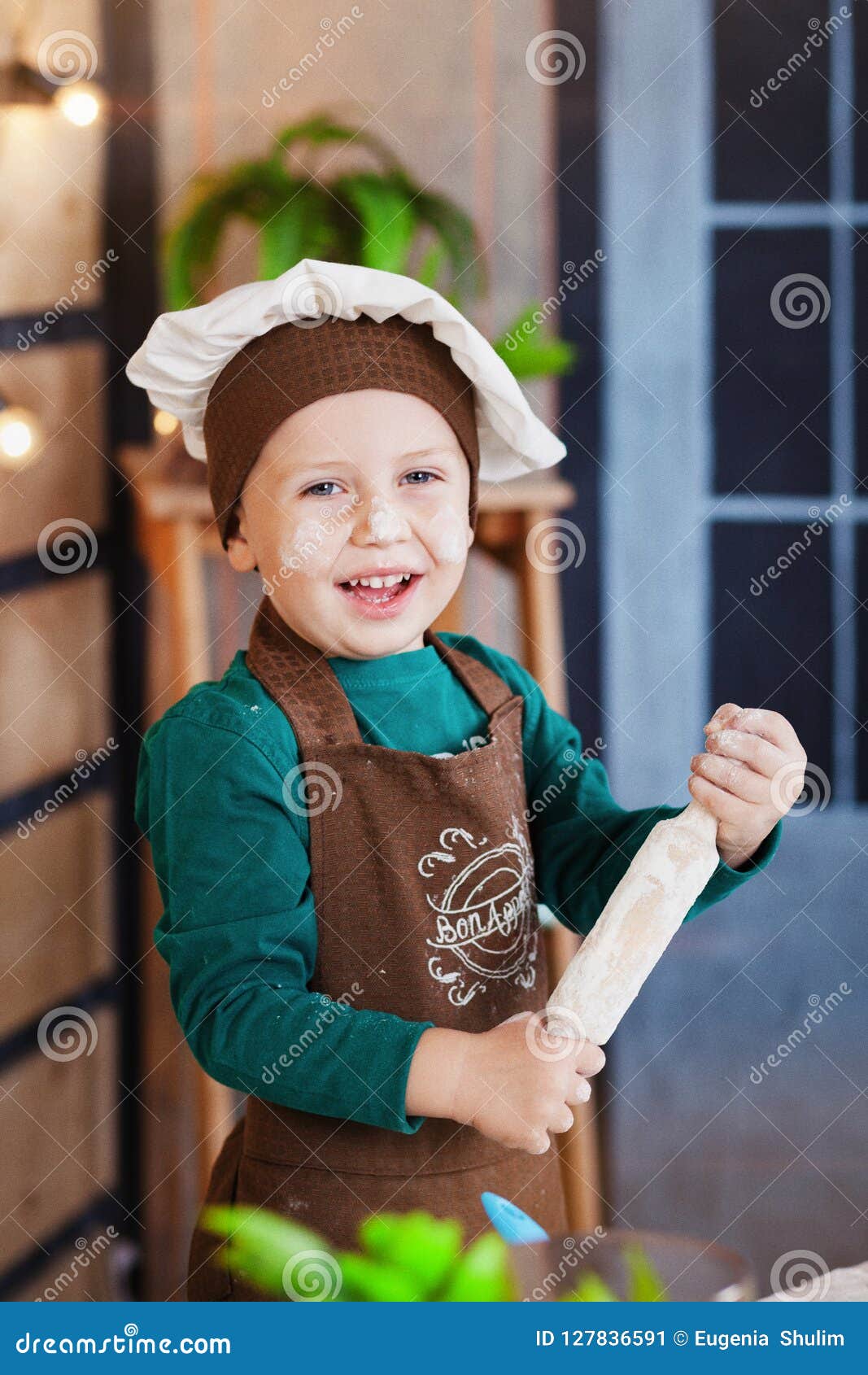 Cheerful Little Boy is Baking Buns. Little Baker. French Buns. F Stock ... Cheerful Little Boy is Baking Buns. Little Baker. French Buns. F Stock ...
