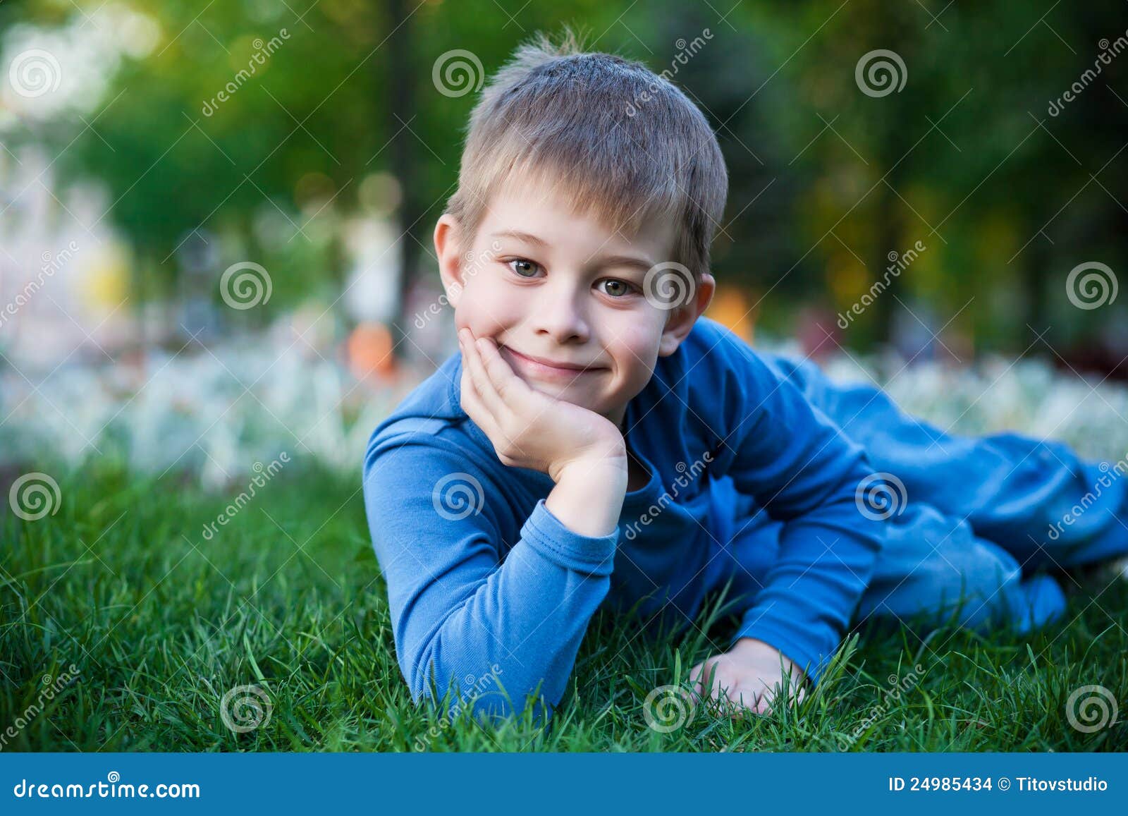 Cheerful Little Boy Laying on the Grass Stock Photo - Image of ...