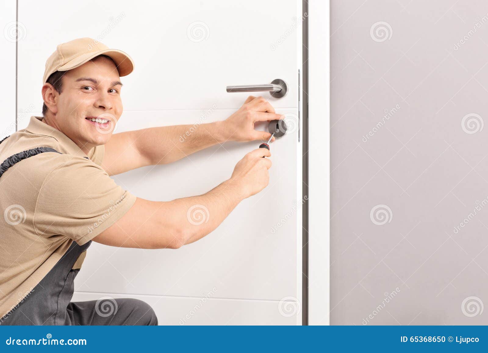Cheerful Locksmith Installing a Door Lock Stock Photo - Image of ...