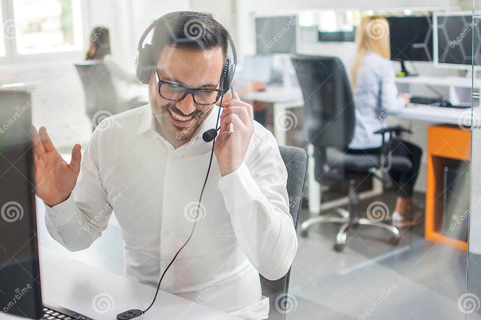 Cheerful Male Technical Support Operator Talking with Customer in Call ...