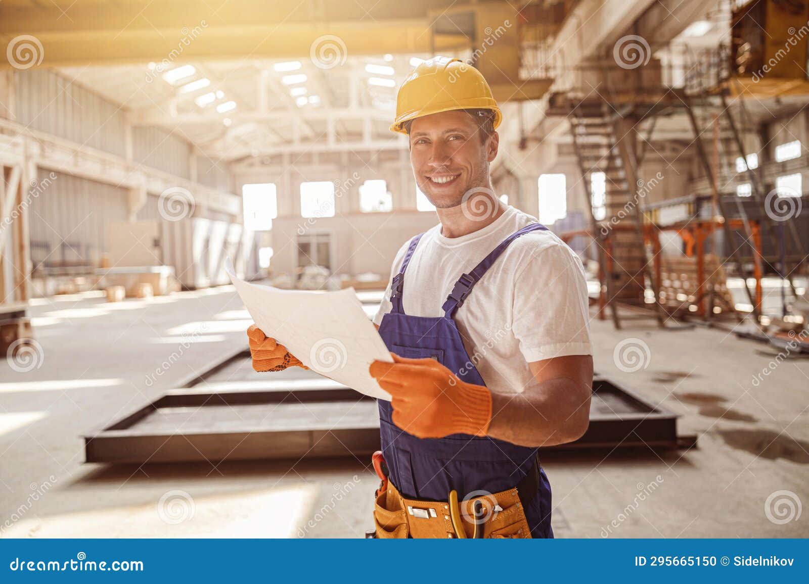 Cheerful Male Worker Holding Building Architectural Plan Stock Photo ...