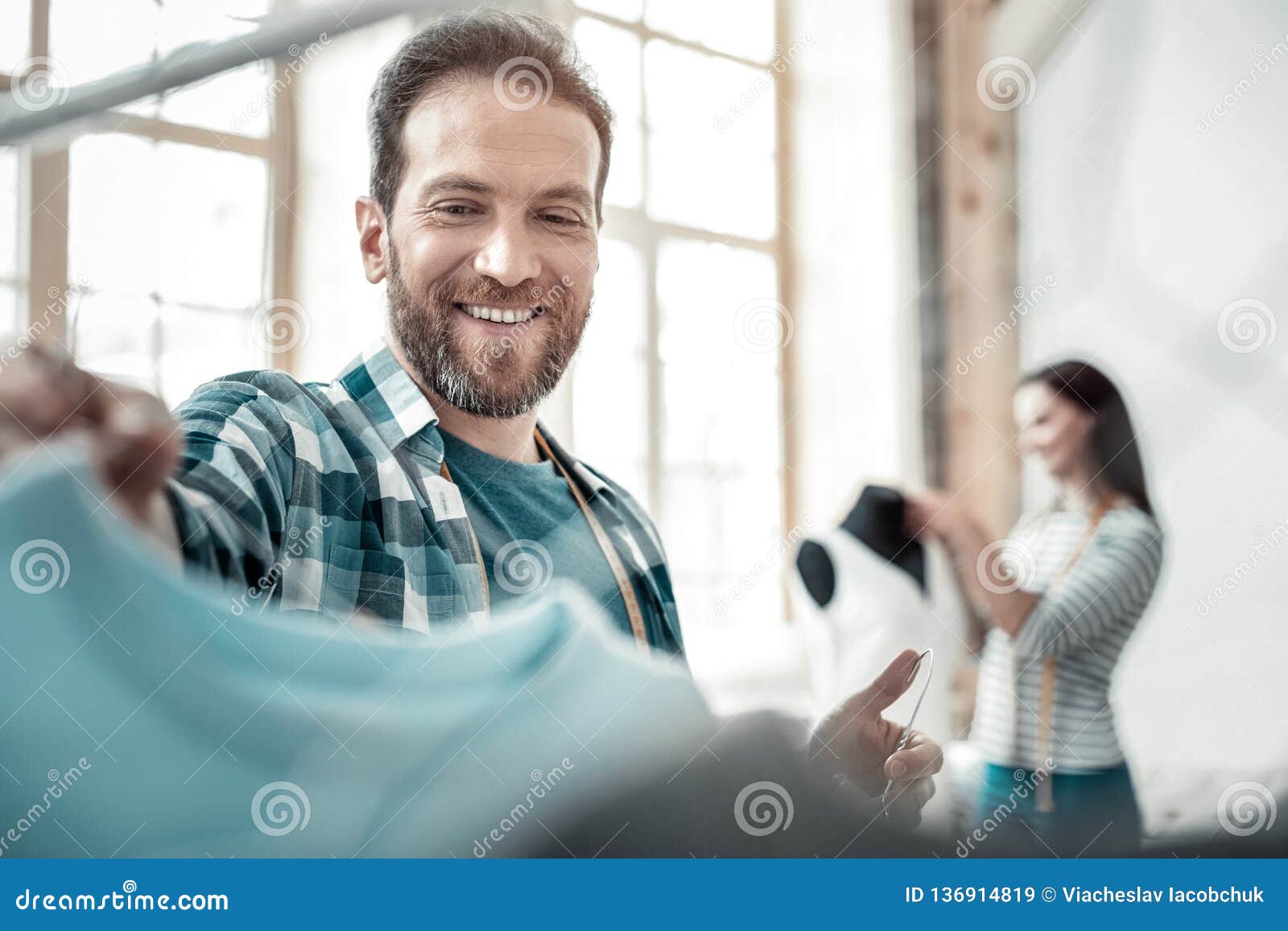 Cheerful Man With Facial Wrinkles Helping In Atelier Of His Wife Stock