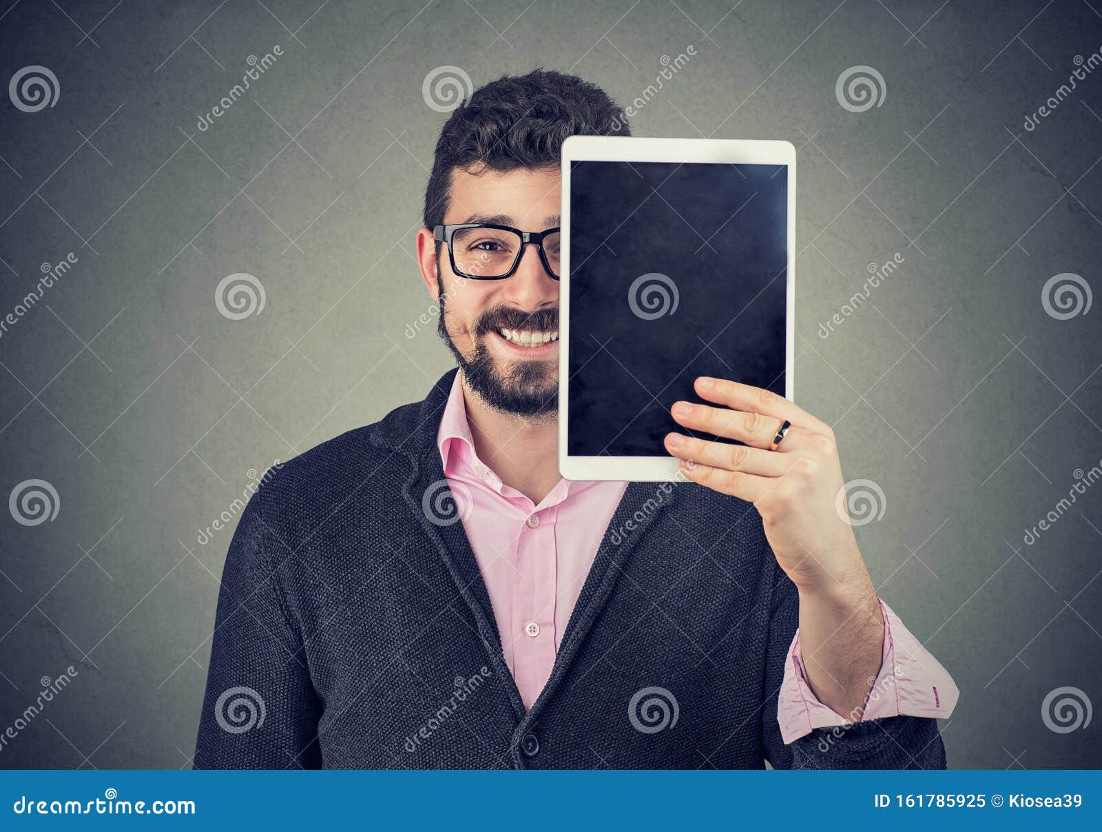 Cheerful Man Holding a Tablet in Front of His Face Stock Image - Image ...