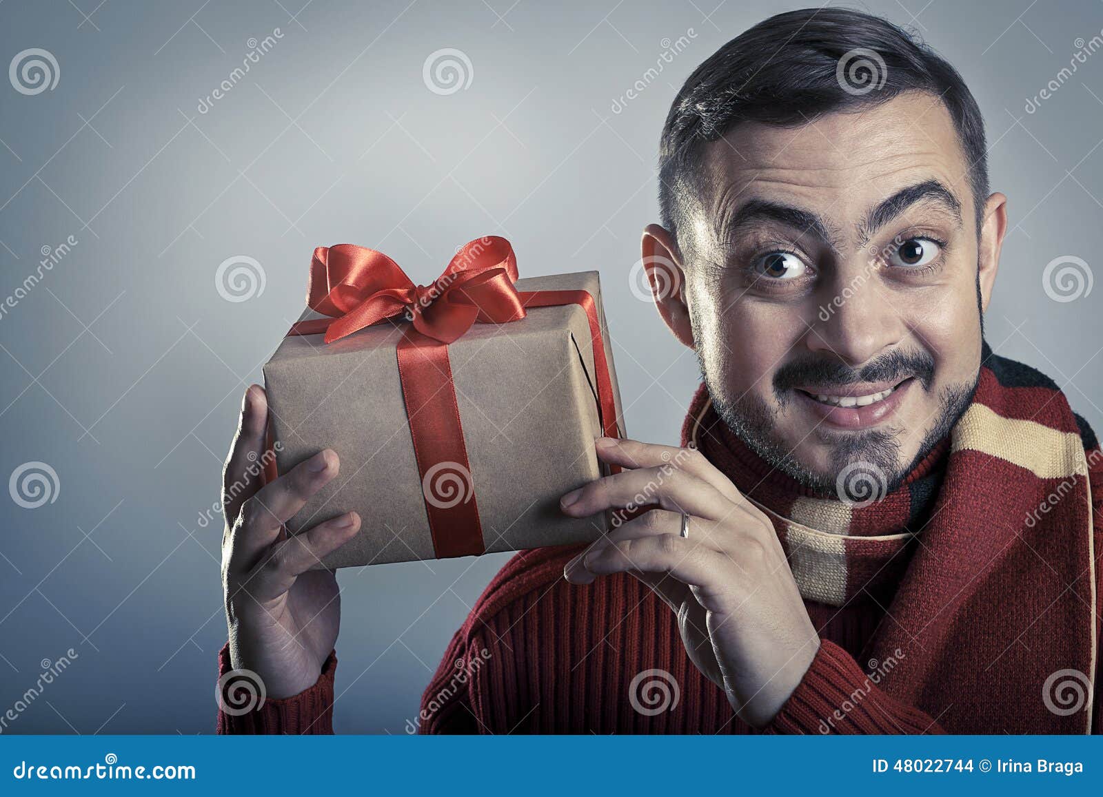 Cheerful Man Shaking the Gift Box and Smiling. Stock Photo - Image of ...