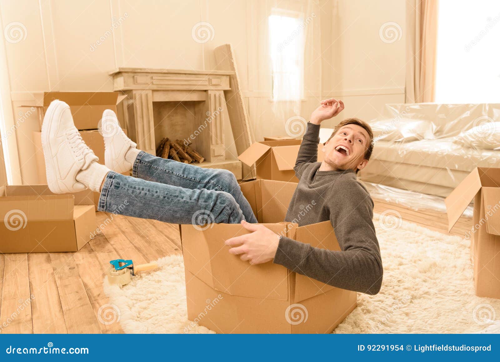 Cheerful Man Sitting in Cardboard Box at New Home Stock Photo - Image ...
