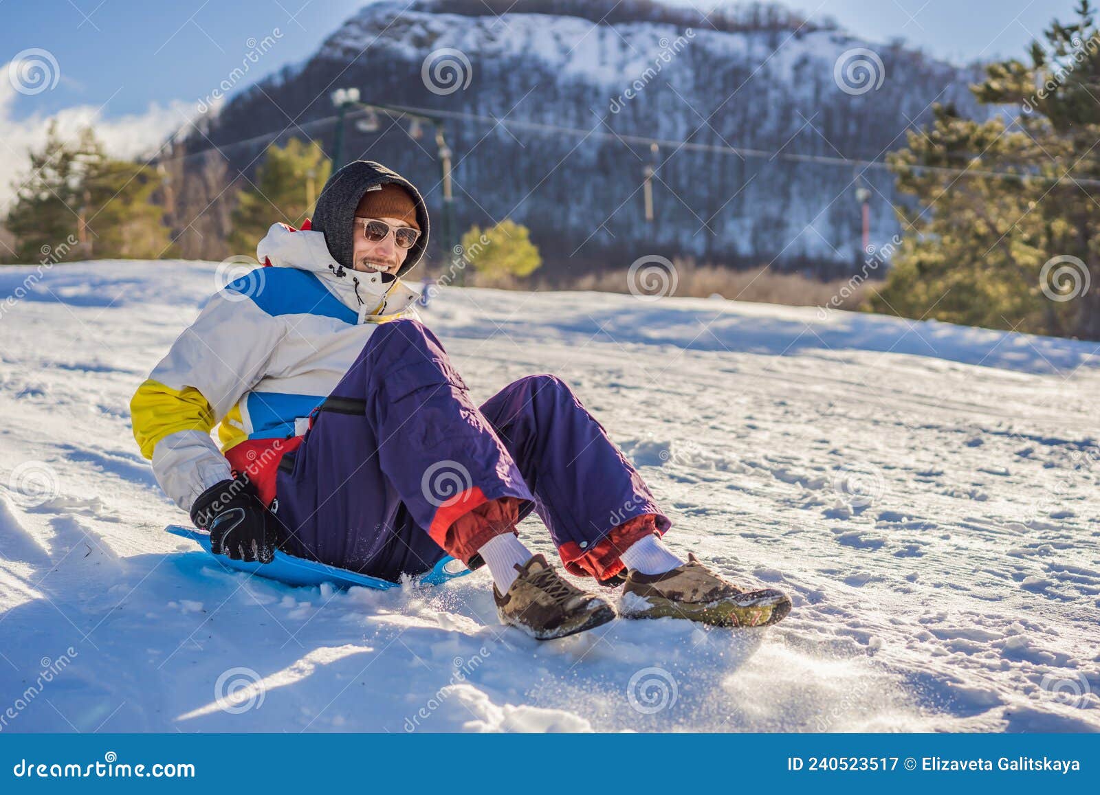 Cheerful Man Sledding Down a Snowy Slope in Full Speed Stock Image ...