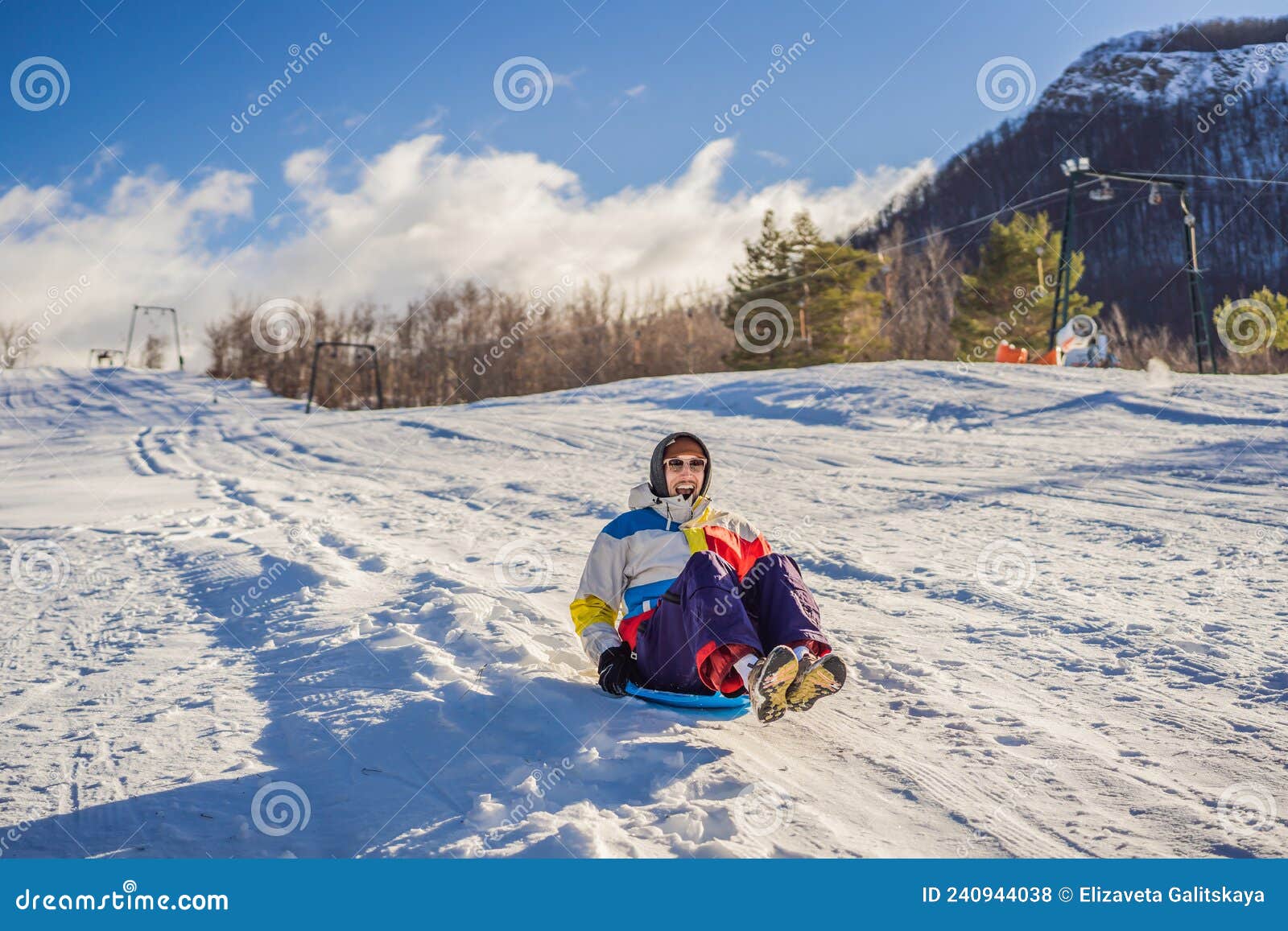 Cheerful Man Sledding Down a Snowy Slope in Full Speed Stock Photo ...