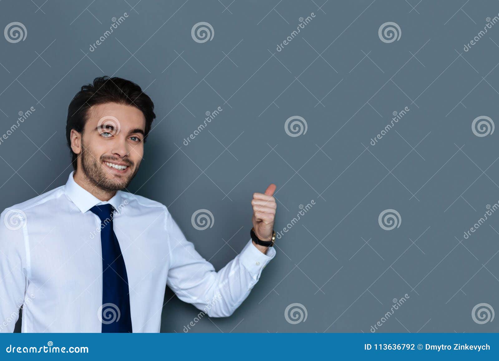 Cheerful Nice Man Pointing at the Wall Stock Photo - Image of emotional ...