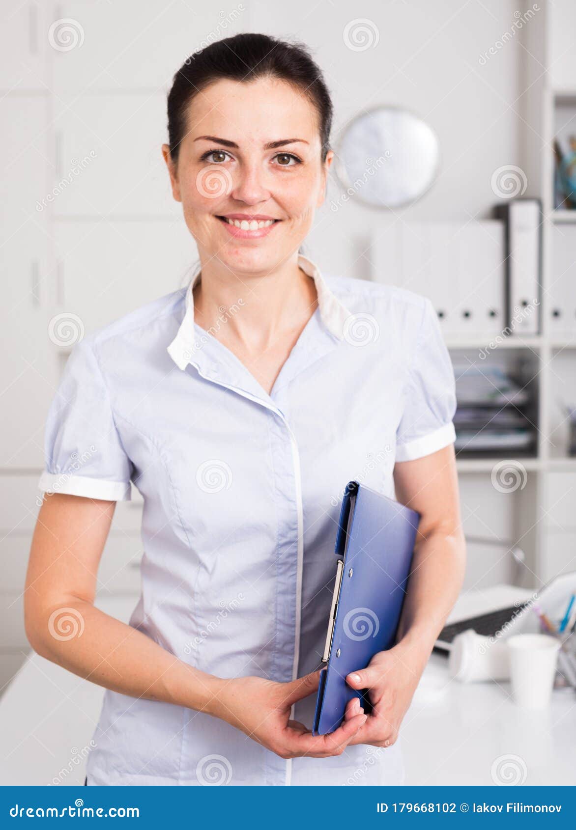 Cheerful Office Worker Standing with Folder Stock Photo - Image of ...