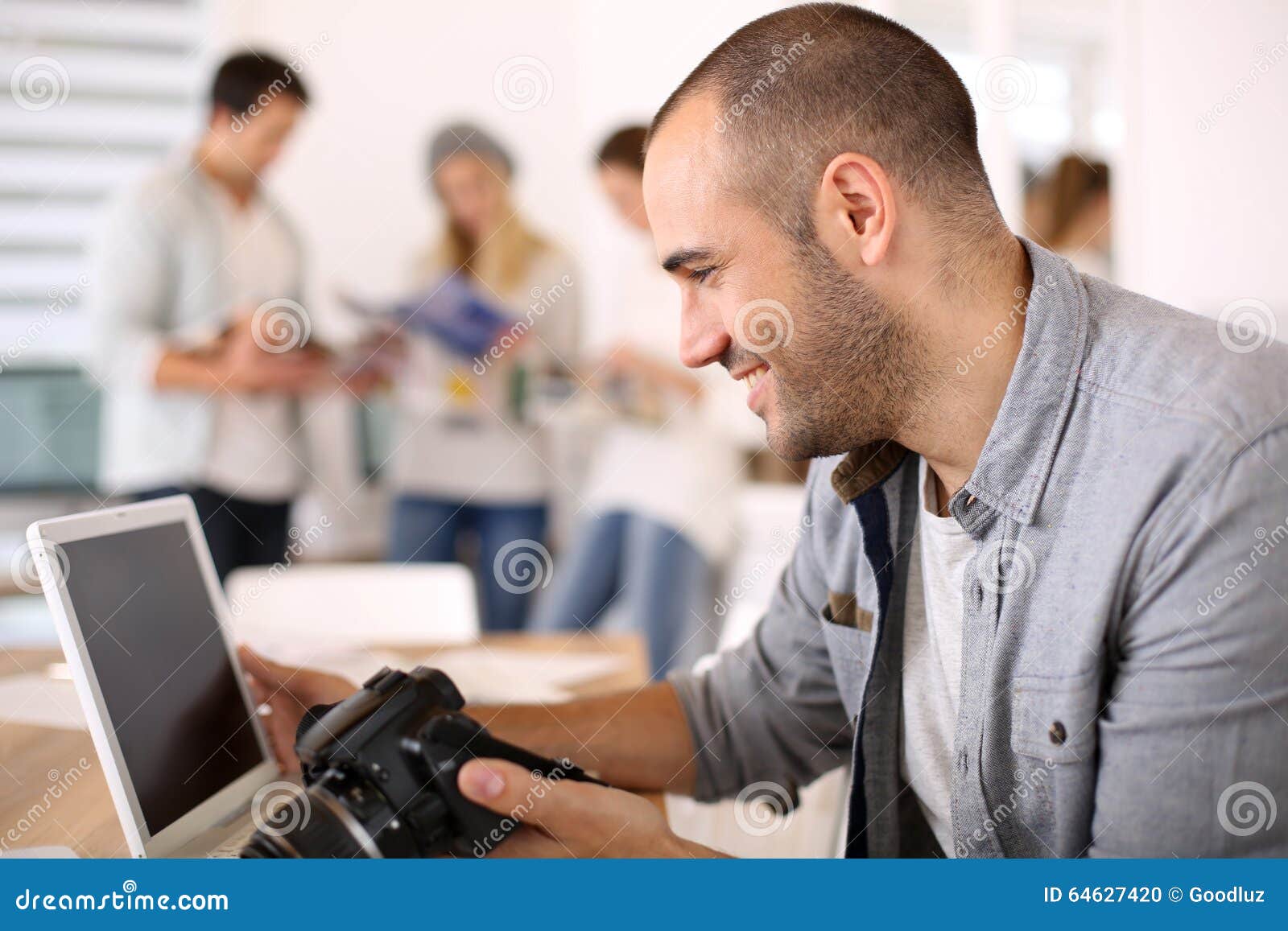 Cheerful Reporter Holding Camera Working on Laptop Stock Photo - Image ...