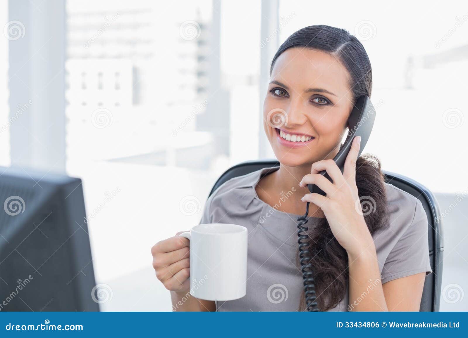 Cheerful Secretary Answering Phone and Drinking Coffee Stock Photo ...