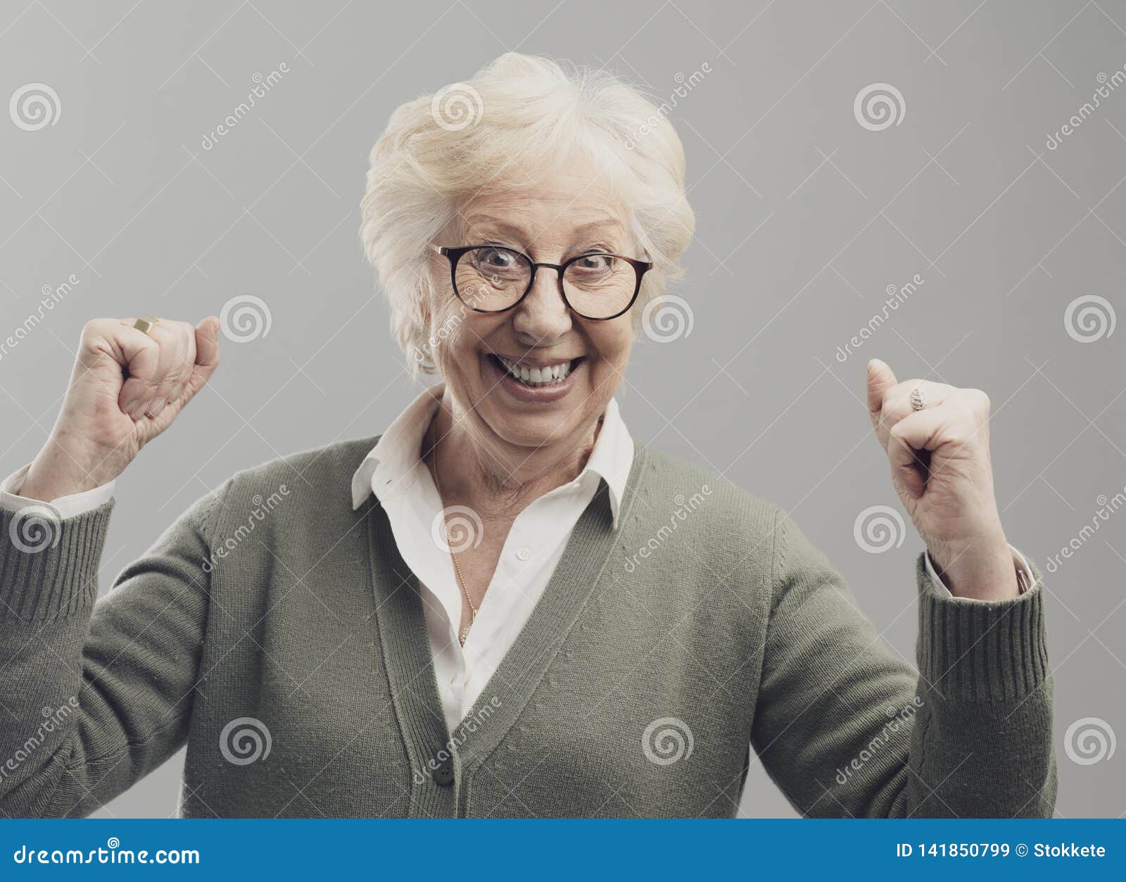 Cheerful Senior Lady Celebrating Her Victory With Raised Fists Stock