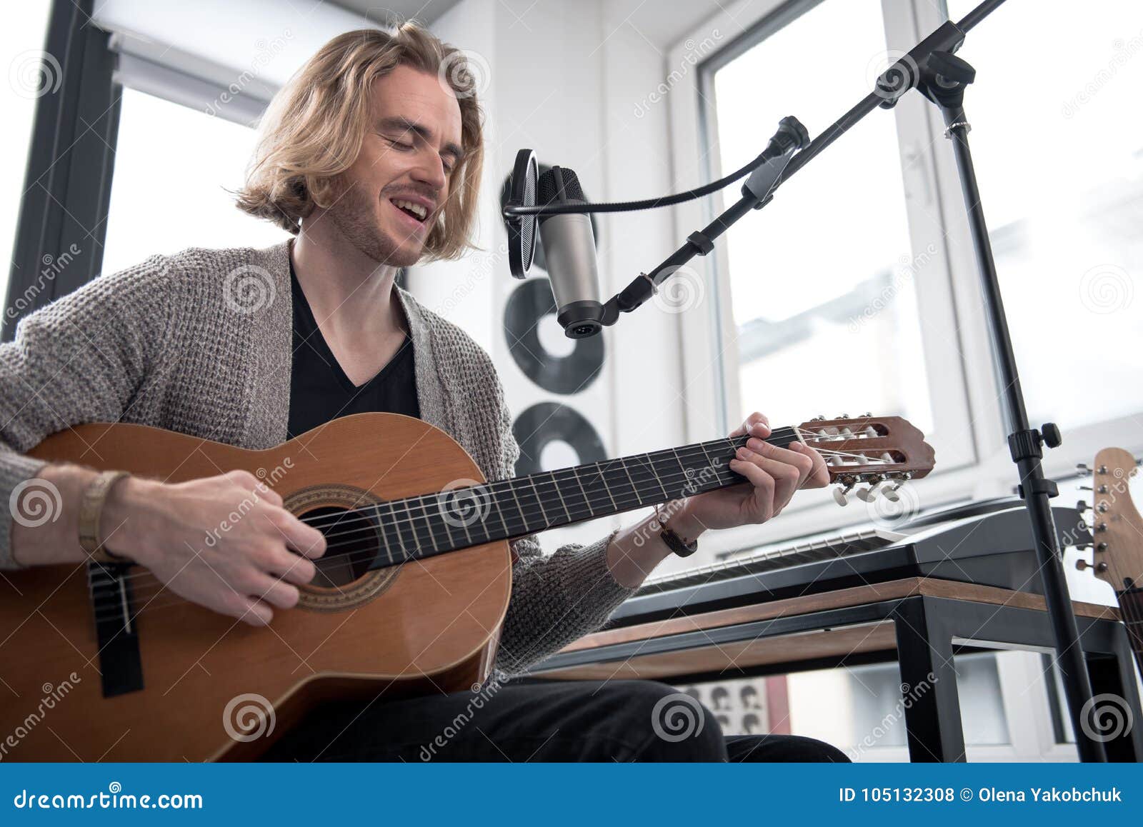 Cheerful Singer Playing Guitar while Introducing His Vocal Stock Photo ...