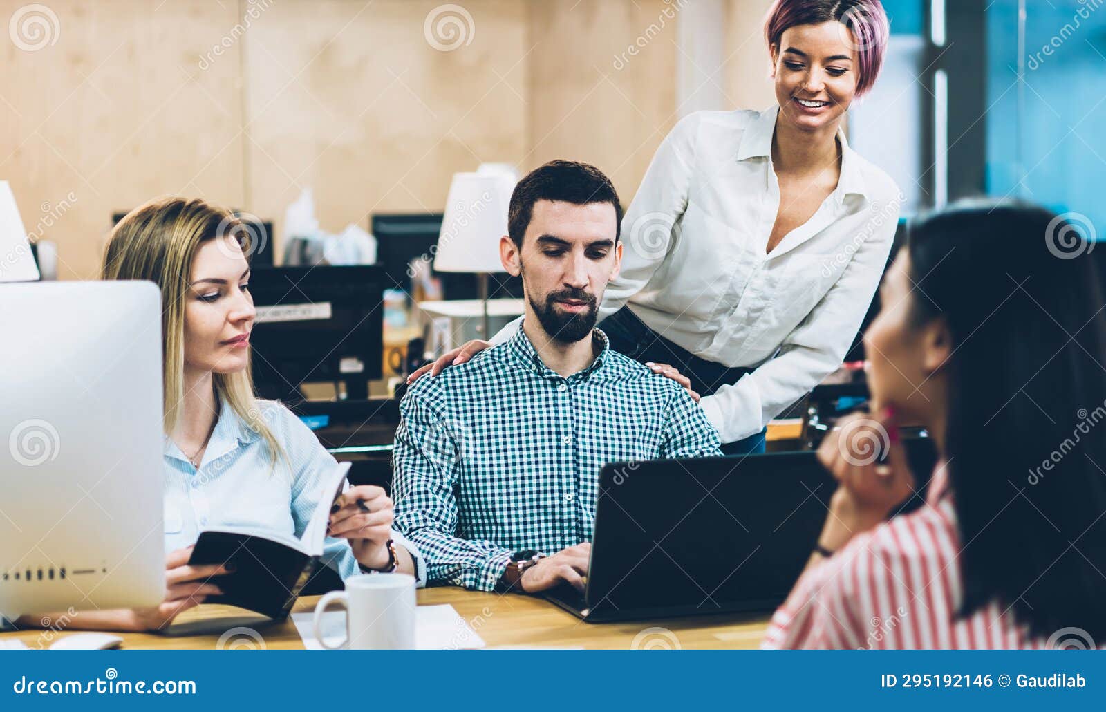 Cheerful Smart Multiethnic Students Working on Computer at Wooden Table ...