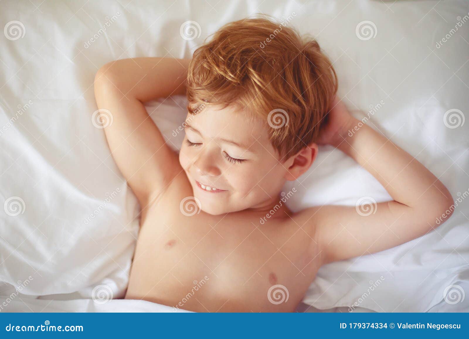Cheerful boy sleep in bed. stock photo. Image of lieless - 179374334 Cheerful boy sleep in bed. stock photo. Image of lieless - 179374334