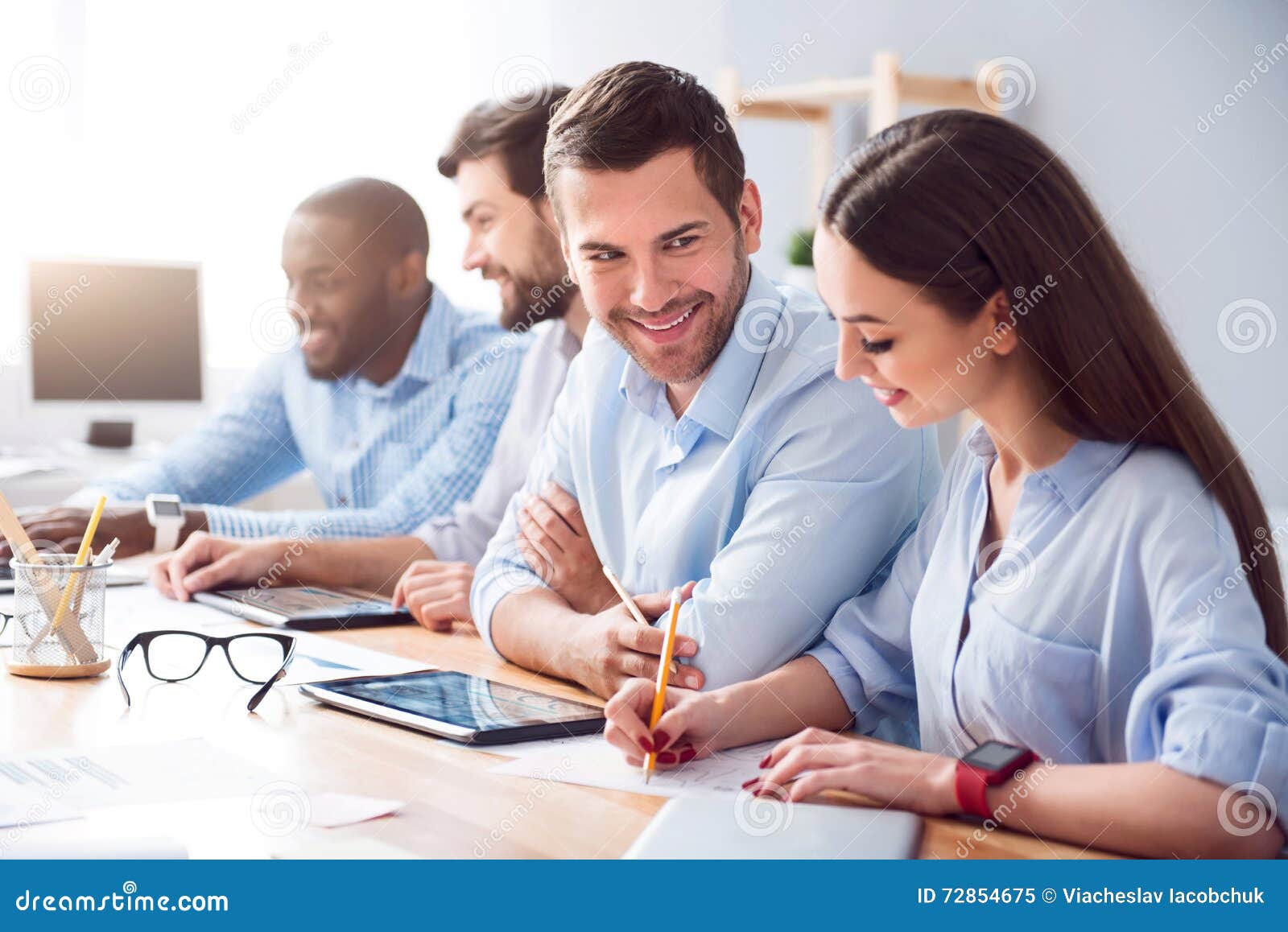Cheerful Smiling Colleagues Sitting at the Table Stock Image - Image of ...