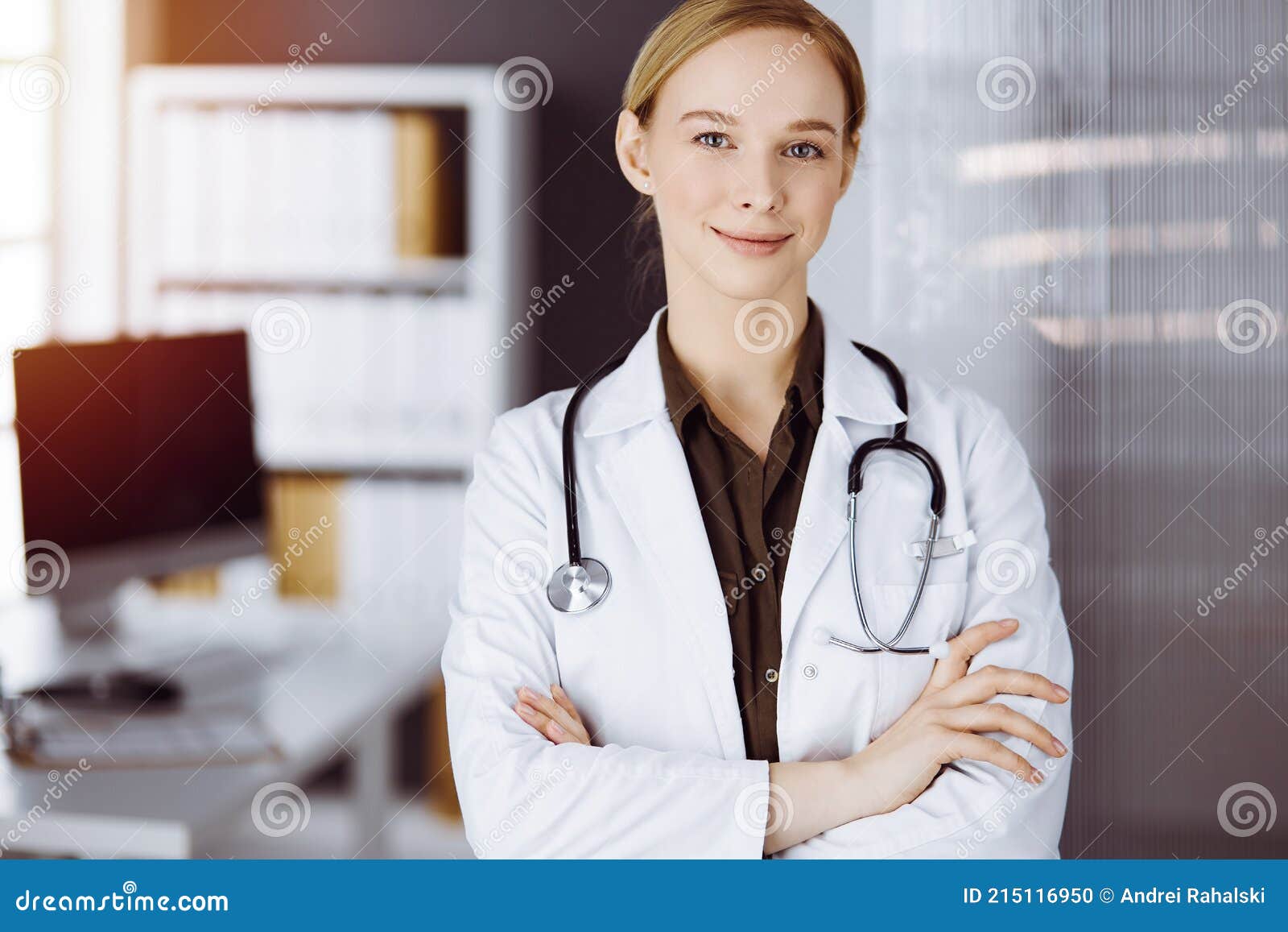 Cheerful Smiling Female Doctor Standing In Clinic Portrait Of Friendly