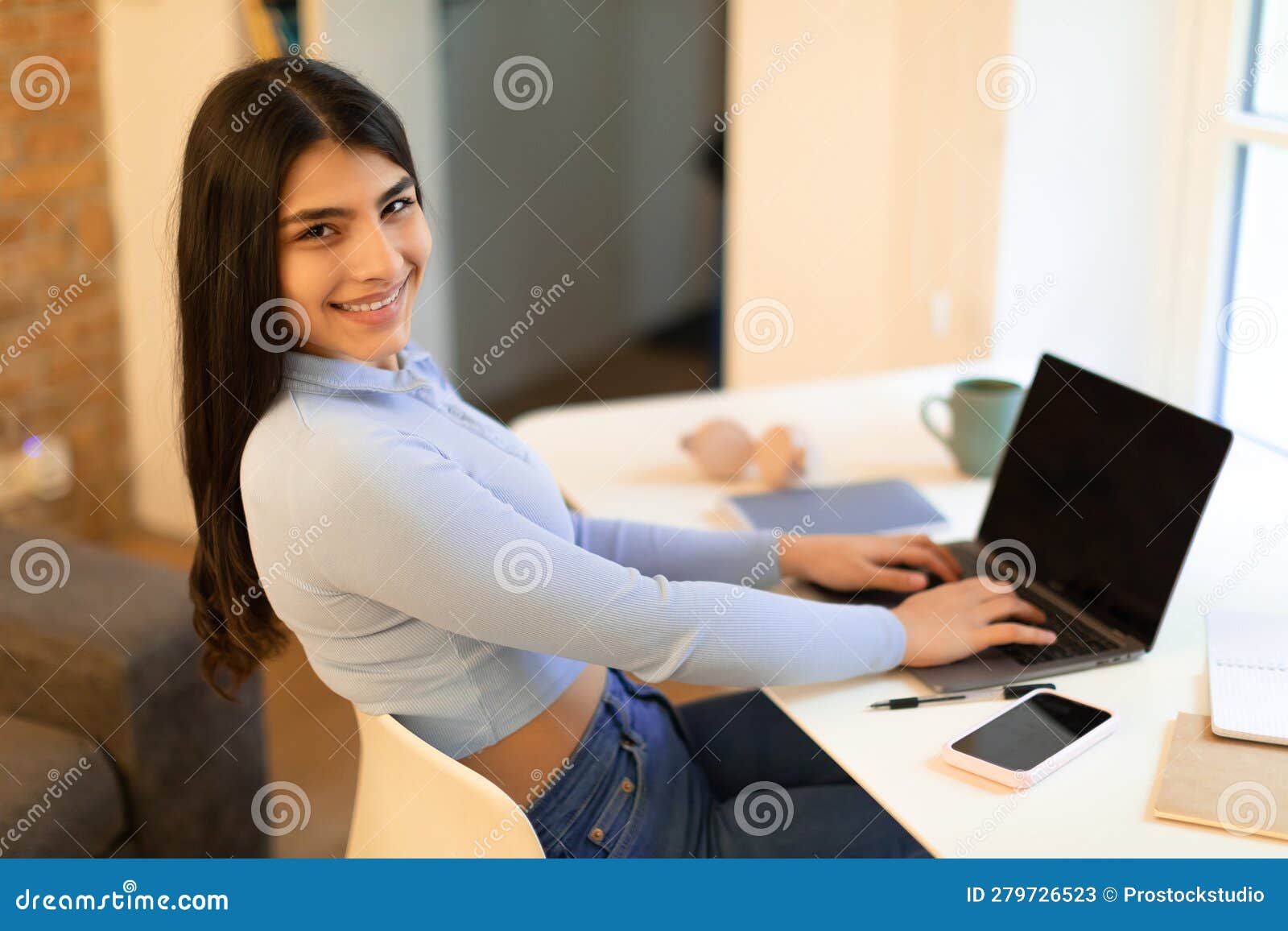 Cheerful Spanish Student Lady Sitting at Desk and Using Laptop Computer ...