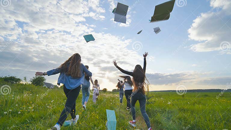 Cheerful Students Run Throwing Notebooks after School at Sunset. Stock ...