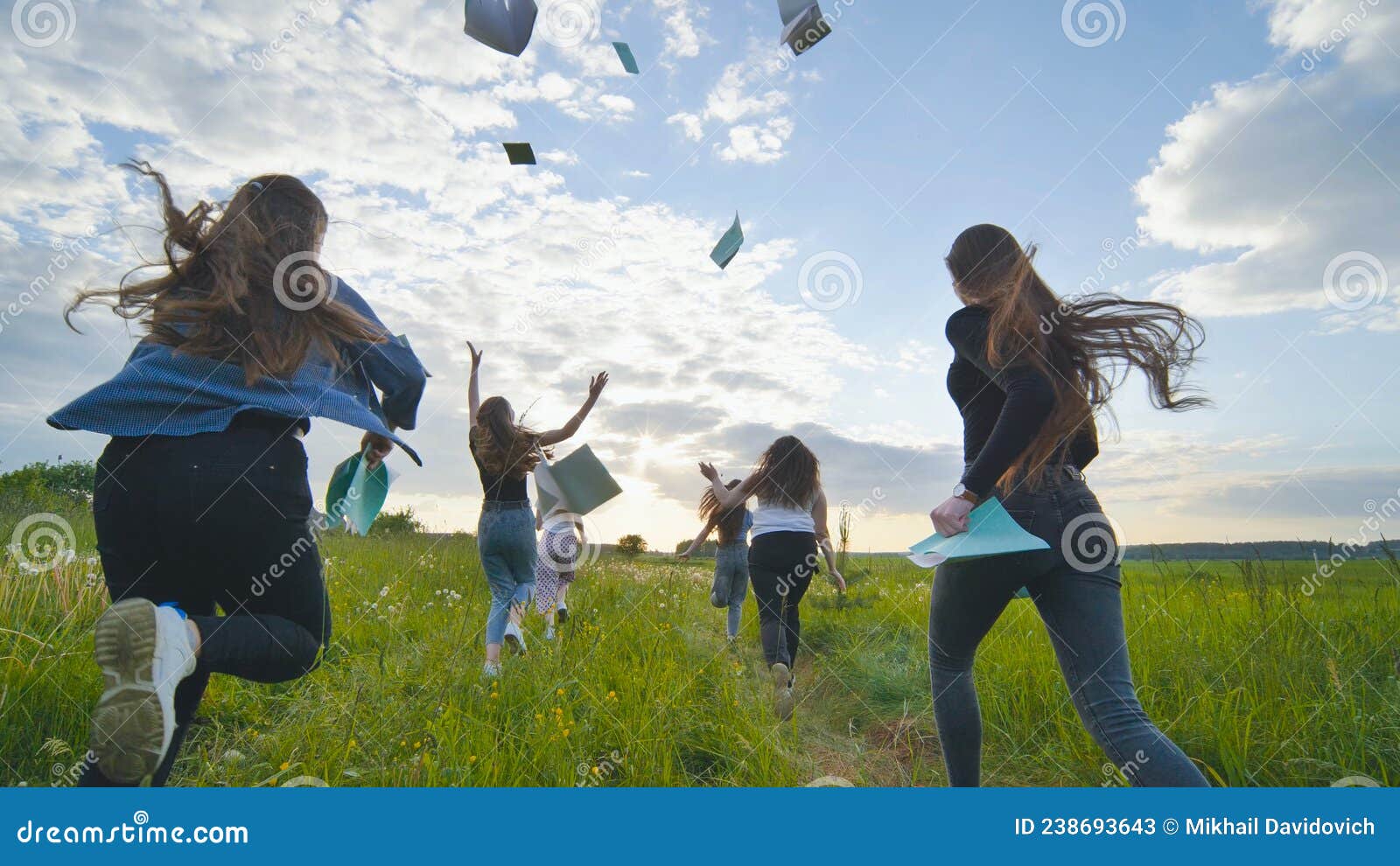Cheerful Students Run Throwing Notebooks after School at Sunset. Stock ...