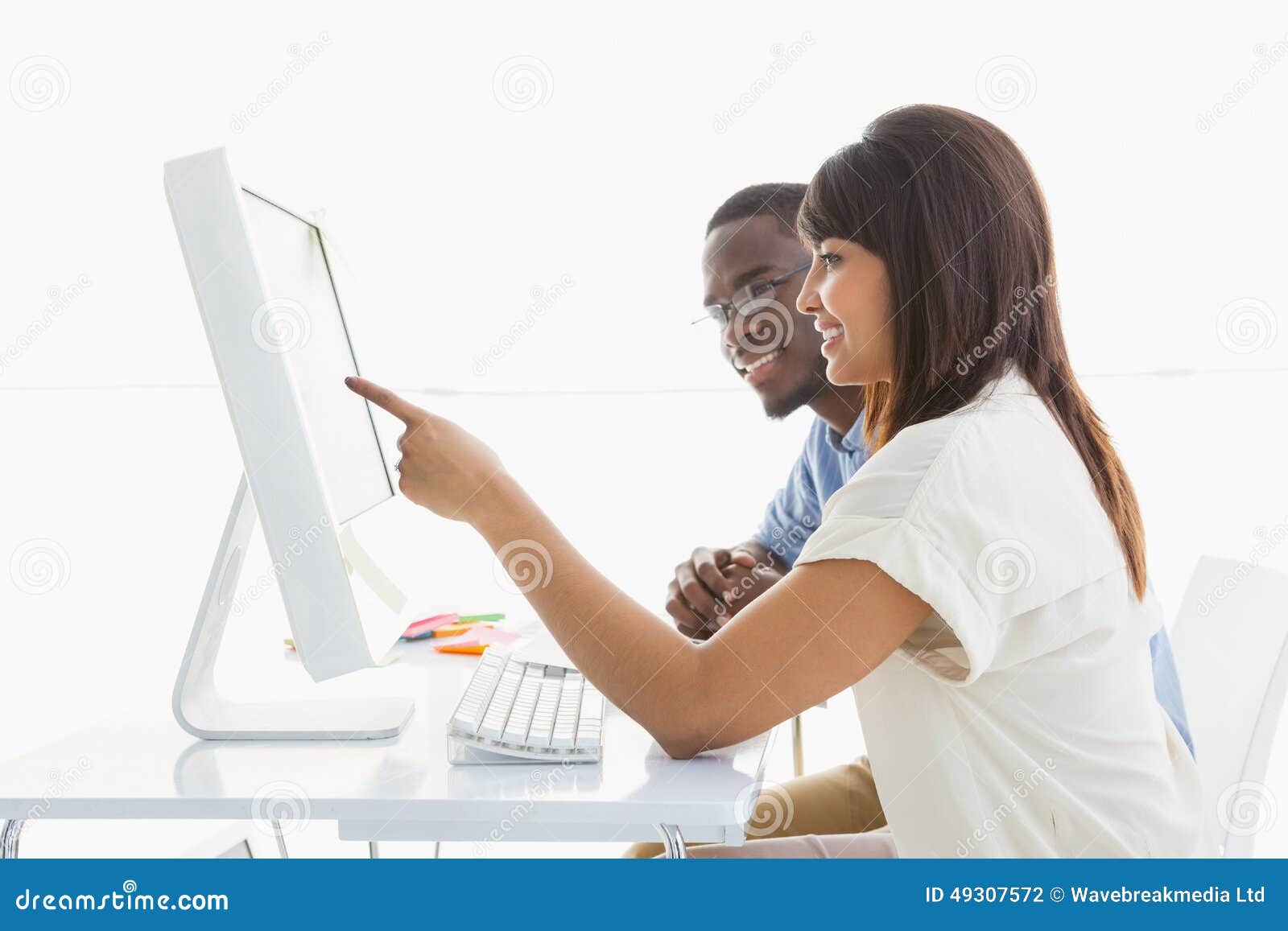 Cheerful Teamwork Using Computer Monitor Stock Photo - Image of editing ...