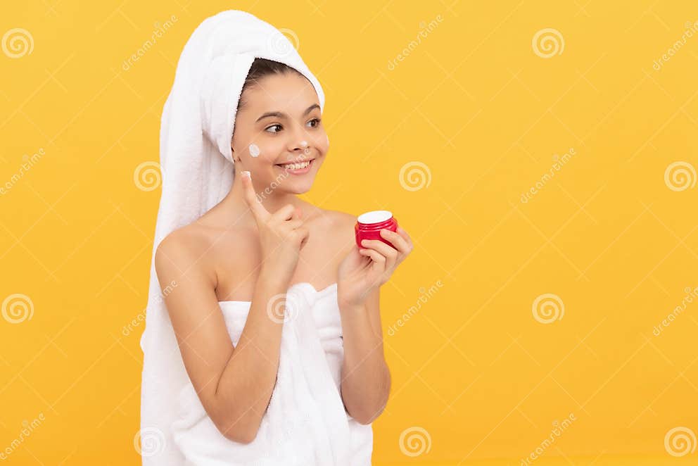 Cheerful Teen Girl In Shower Towel Apply Facial Cream Stock Image