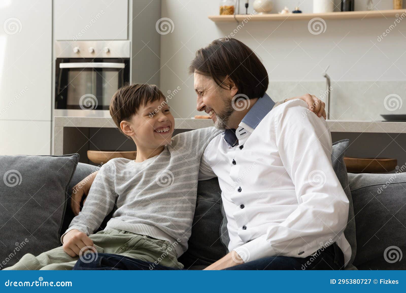 Cheerful Teenage Son and Dad Chatting in Living Room Stock Image ... Cheerful Teenage Son and Dad Chatting in Living Room Stock Image ...