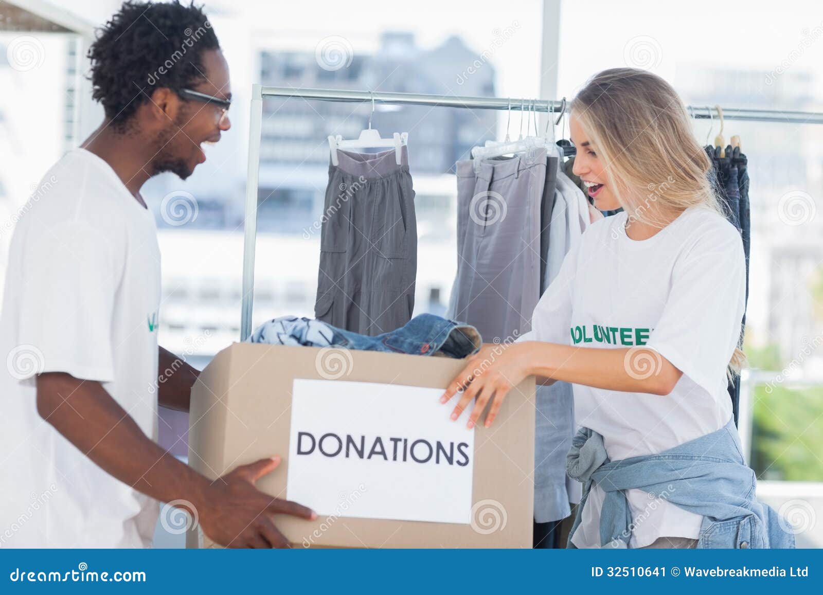 Cheerful Volunteers Looking at a Donation Box Stock Image - Image of ...
