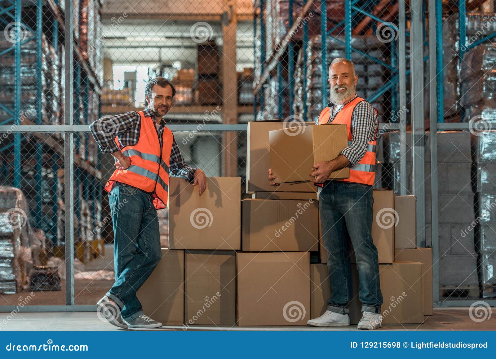 Cheerful Warehouse Workers Standing with Boxes and Smiling Stock Photo ...