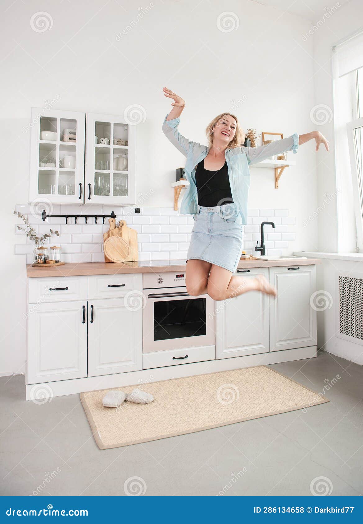 Cheerful Woman Jumping and Dancing in the Kitchen Stock Photo - Image ...