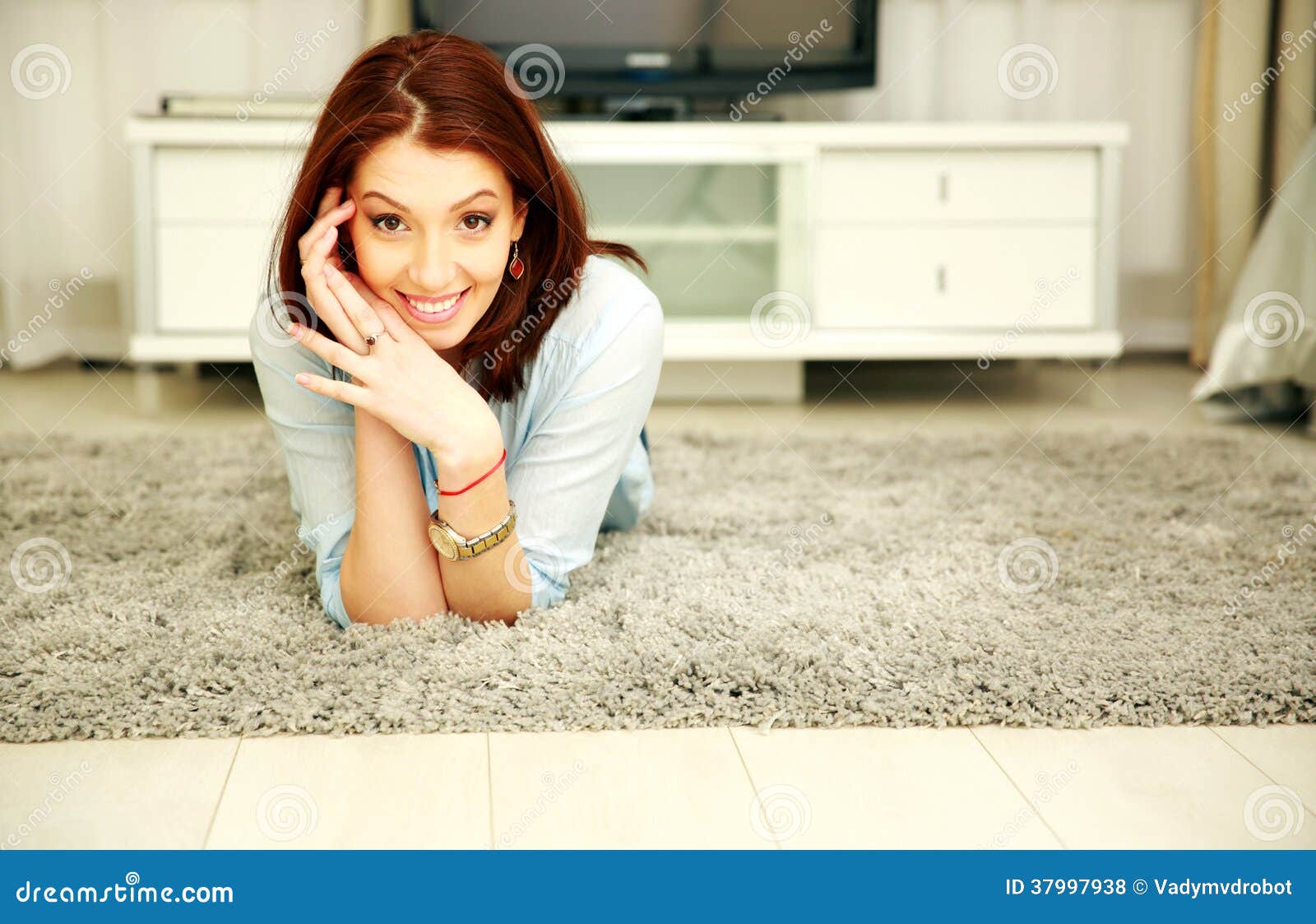 Cheerful Woman Lying on the Carpet Stock Photo - Image of happiness ...