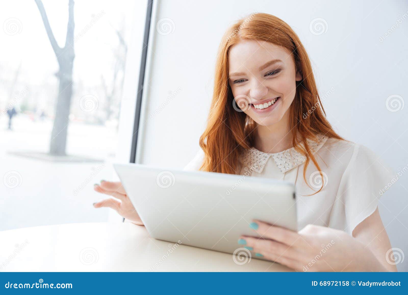Cheerful Woman Smiling and Using Tablet in Cafe Stock Photo - Image of ...