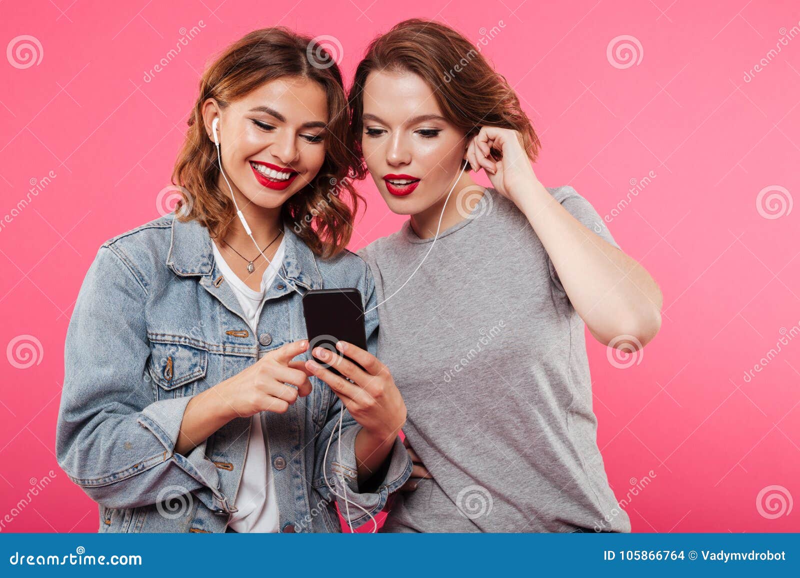 Cheerful Women Friends Using Mobile Phone Listening Music. Stock Photo ... Cheerful Women Friends Using Mobile Phone Listening Music. Stock Photo ...