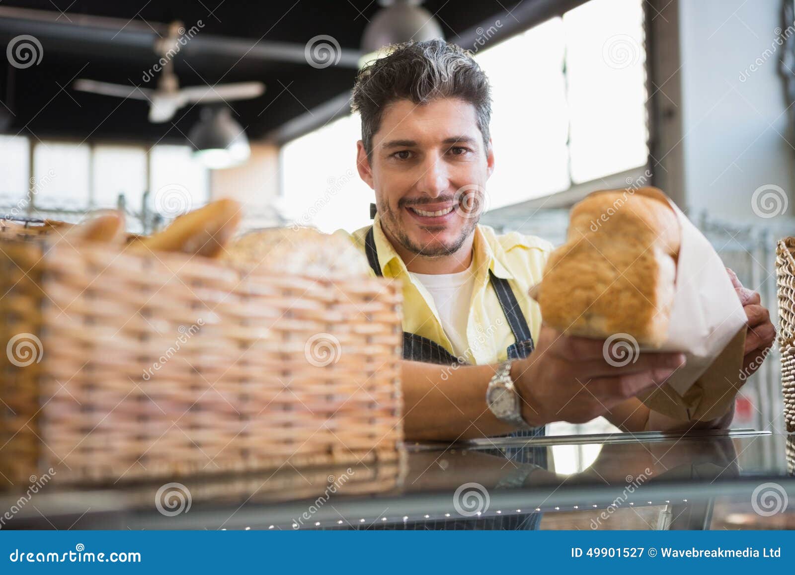 Cheerful Worker Standing and Presenting a Bread Stock Image - Image of ...
