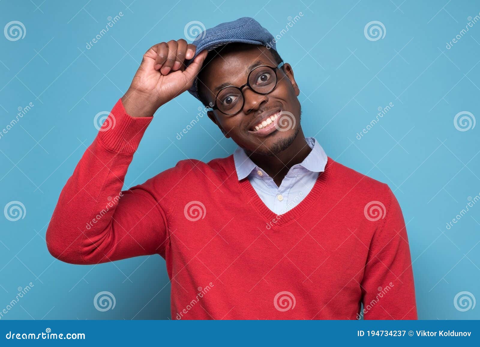 Cheerful Young African Man Greets by Taking Off a Hat Stock Image ...
