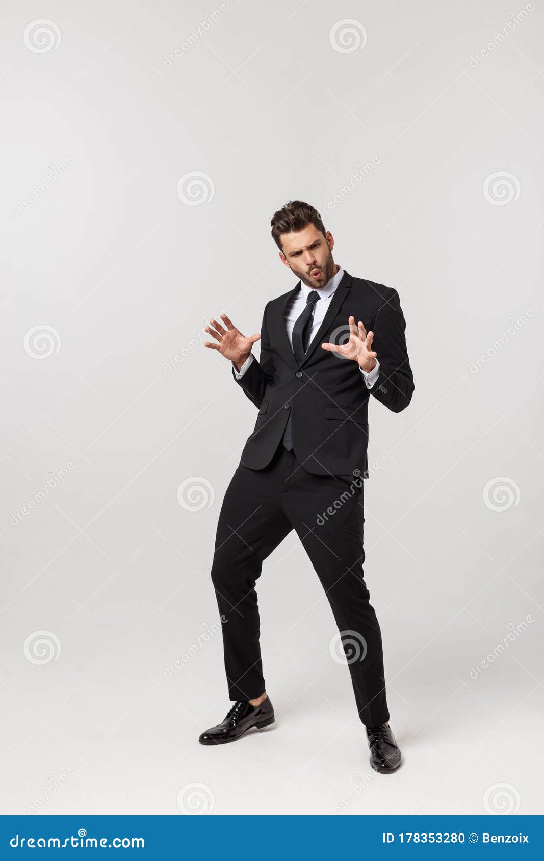 Cheerful Young Bearded Business Man Show Hand Up Excited With Clenched