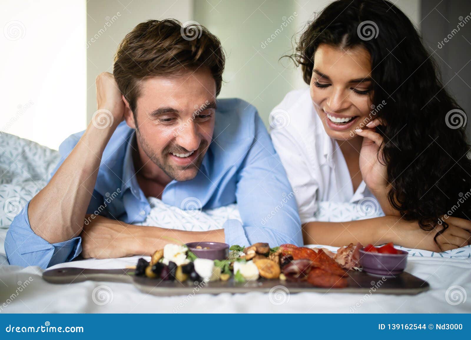 Cheerful Young Couple Having Breakfast in Bed Stock Photo - Image of ... Cheerful Young Couple Having Breakfast in Bed Stock Photo - Image of ...