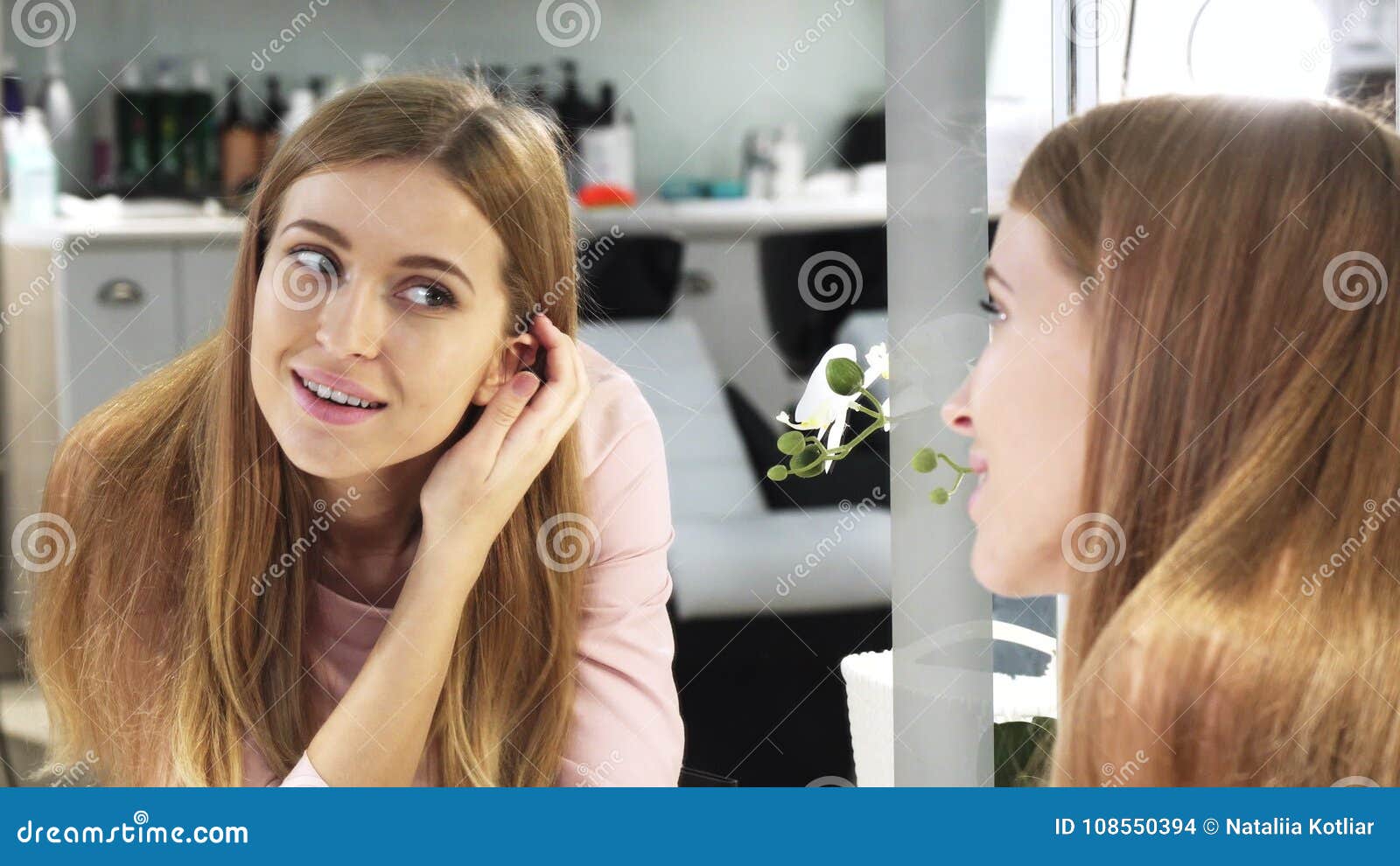 Young Long Haired Beautiful Woman Looking In The Mirror At Beauty Salon