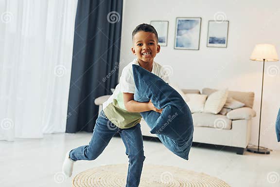 Cheerful Young Boy is at Home Alone Stock Photo - Image of casual, mood ...