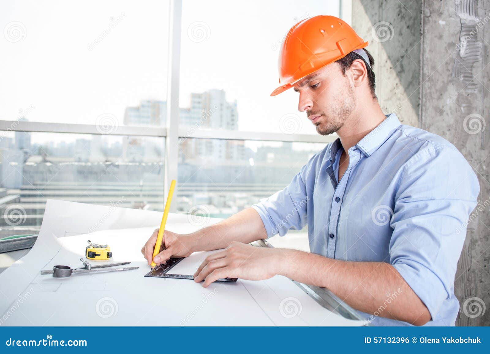 Cheerful Young Builder is Designing the Plan of Stock Photo - Image of ...