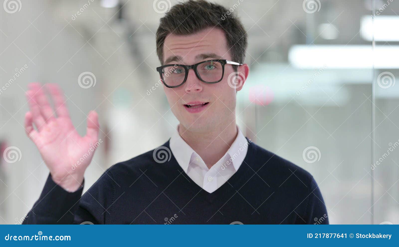 Cheerful Young Businessman Waving at the Camera Stock Image - Image of ...