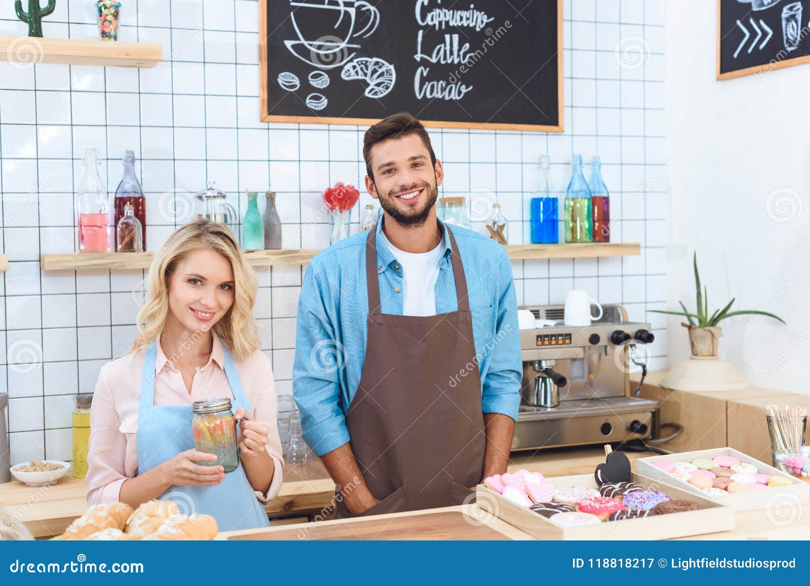 Cheerful Young Cafe Workers in Aprons Smiling Stock Image - Image of ...