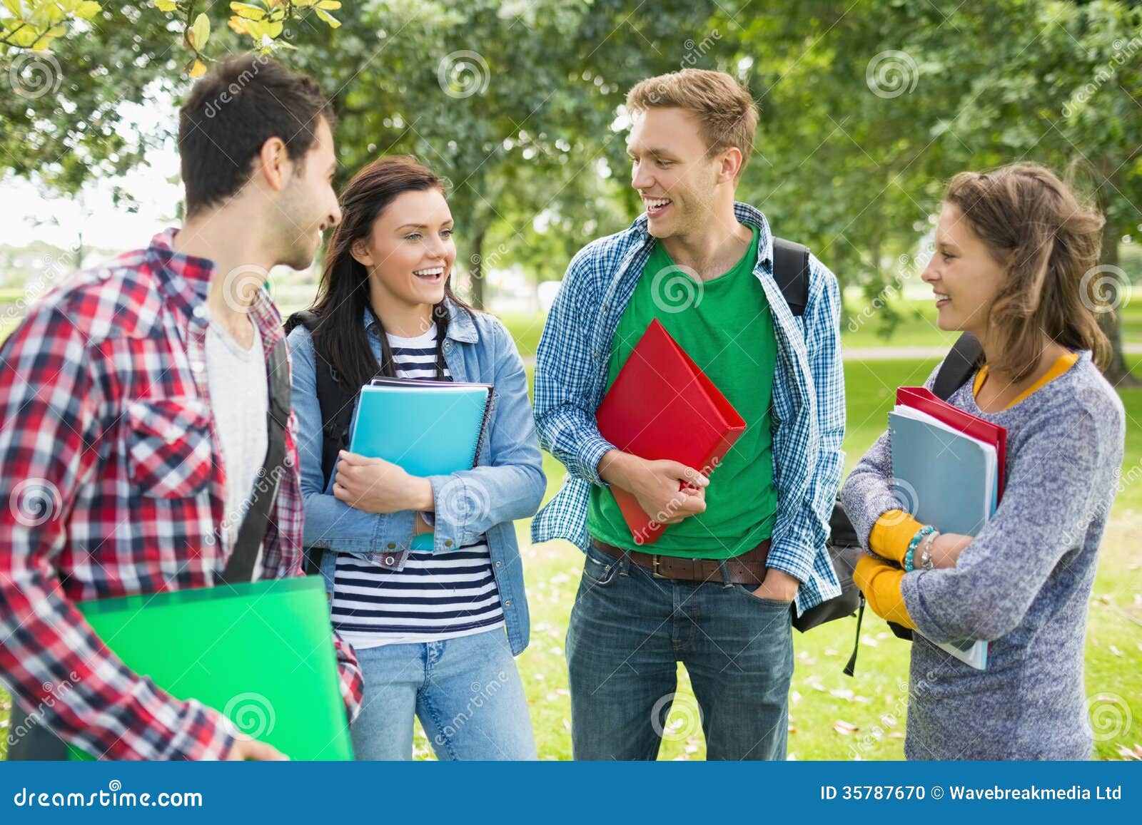 Cheerful Young College Students in Park Stock Photo - Image of smiling ...