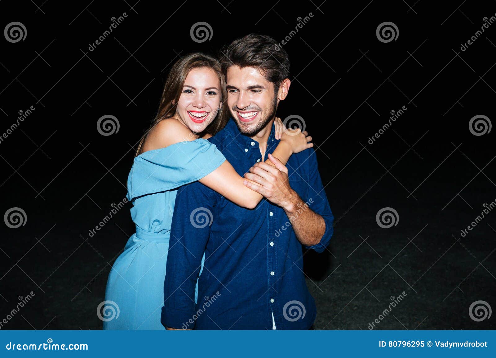 Cheerful Young Couple Hugging on the Beach at Night Stock Image - Image ...
